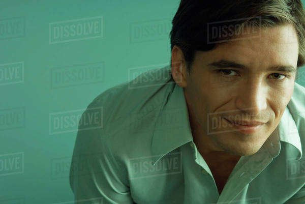 Man smiling, leaning forward, looking at camera - Royalty-free Stock ...