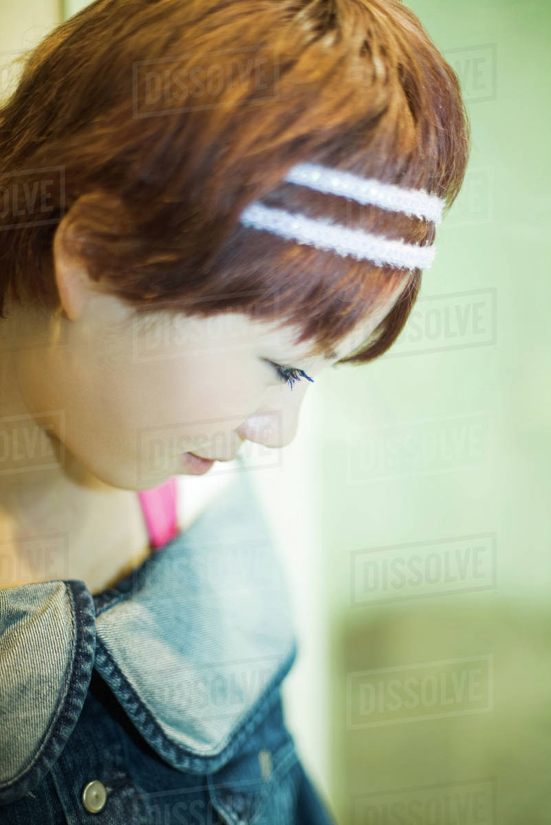 Young woman looking down, head down, side view - Royalty-free Stock ...