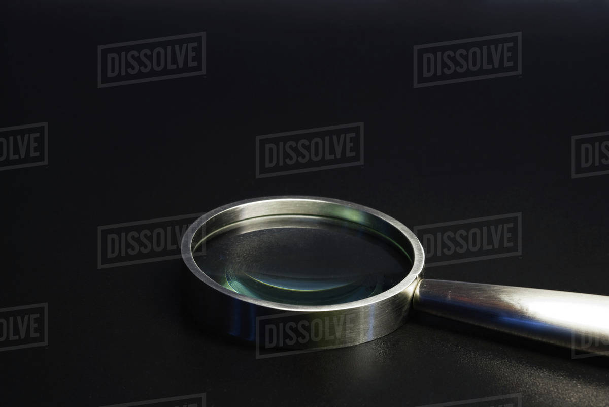 Magnifying glass, close-up - Royalty-free Stock Photo | Dissolve