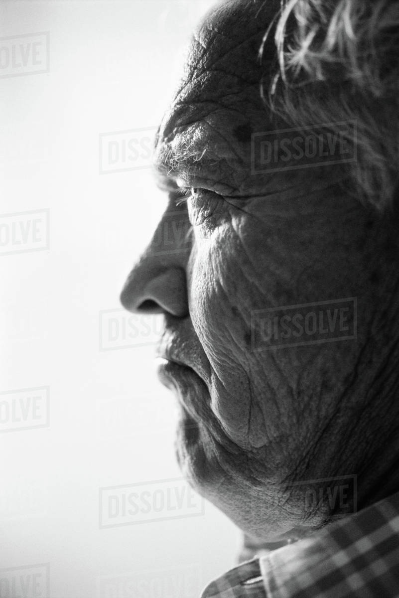Man frowning, profile, portrait - Royalty-free Stock Photo | Dissolve
