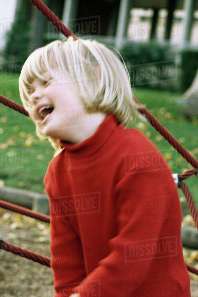 Child outdoors, smiling, looking away - Royalty-free Stock Photo | Dissolve