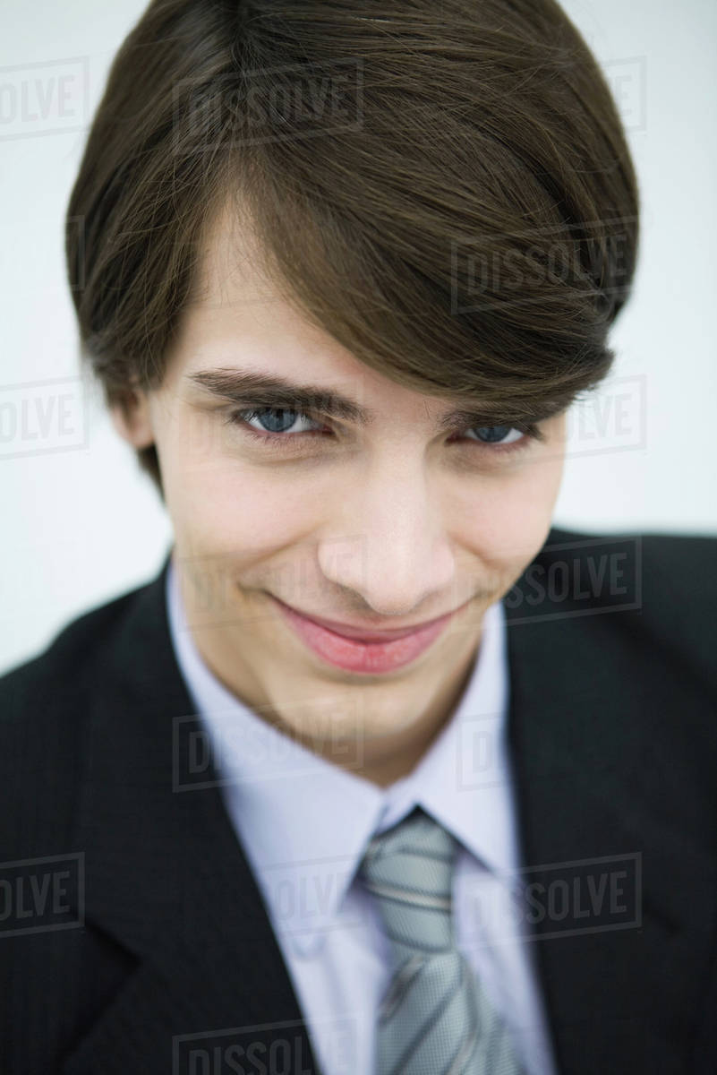 Young man in suit smiling at camera, portrait - Royalty-free Stock ...