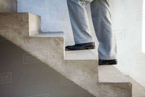 Man walking up staircase, side view, cropped - Royalty-free Stock Photo ...