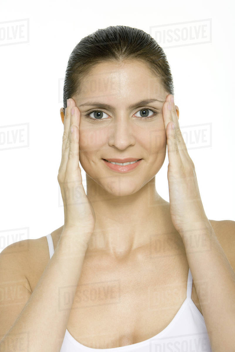 Woman holding face in hands, smiling at camera, portrait - Royalty-free ...