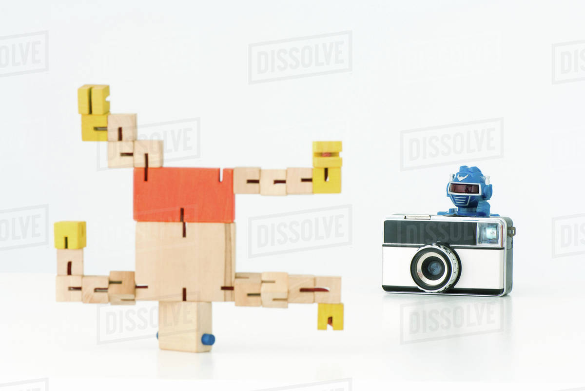 Robot taking photo of second robot breakdancing - Stock Photo - Dissolve