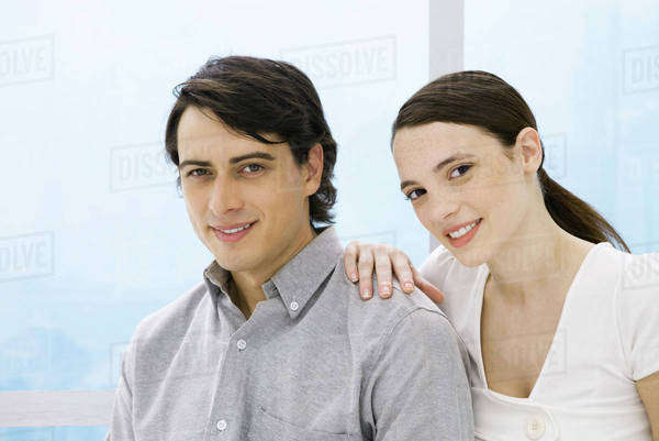 Couple smiling at camera, portrait - Royalty-free Stock Photo | Dissolve