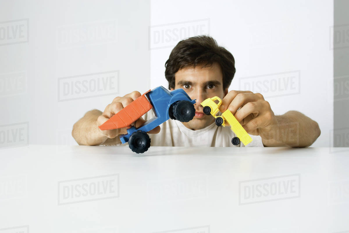 Man playing with toy trucks - Royalty-free Stock Photo | Dissolve
