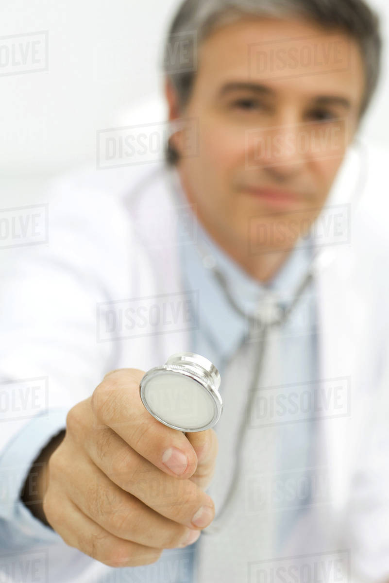 Doctor holding stethoscope toward camera, focus on foreground - Royalty ...