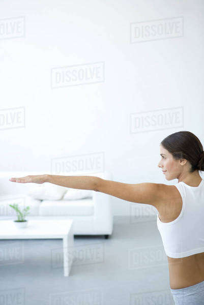 Woman stretching, one arm extended, side view - Royalty-free Stock ...