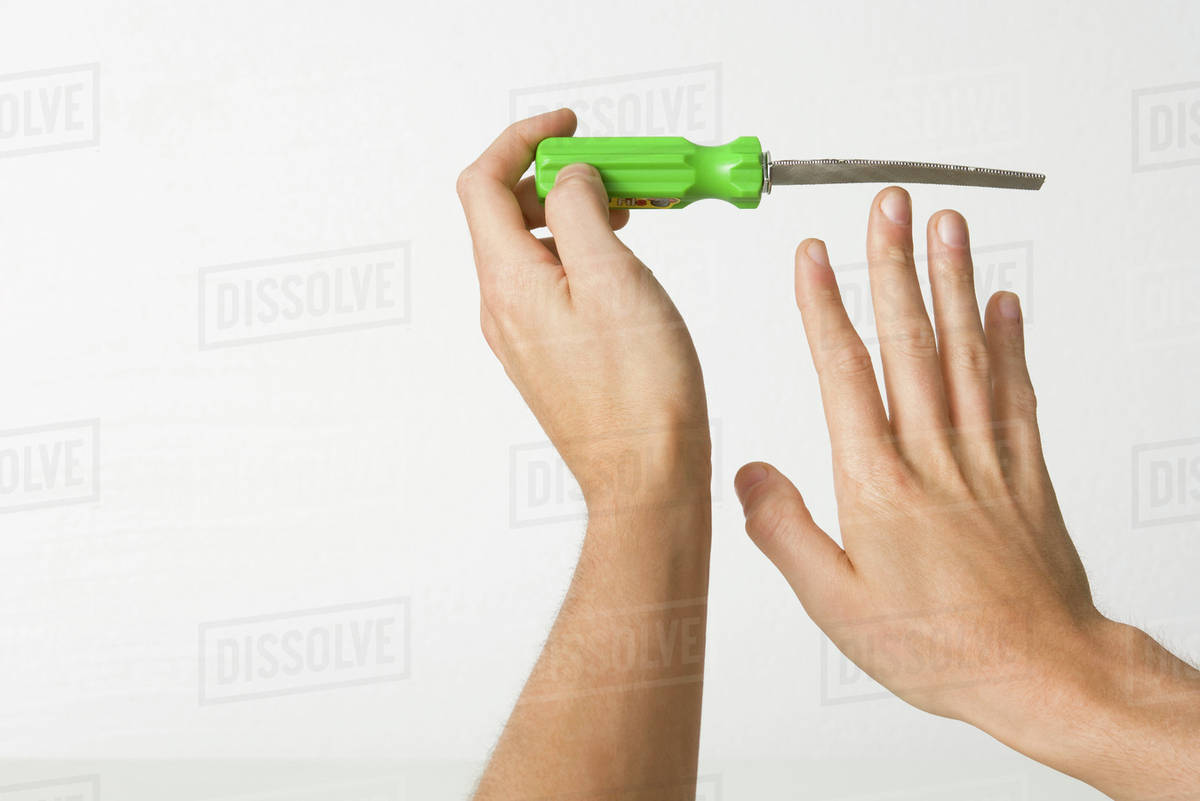 Hands holding sharp file - Stock Photo - Dissolve