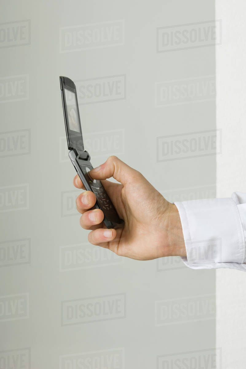 Hand holding cell phone, text messaging, cropped view - Stock Photo ...