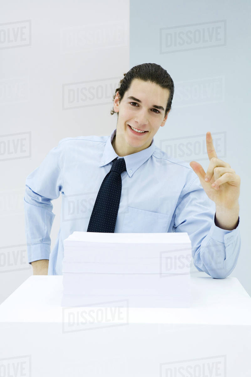 Young man leaning on counter, gesturing, speaking - Royalty-free Stock ...