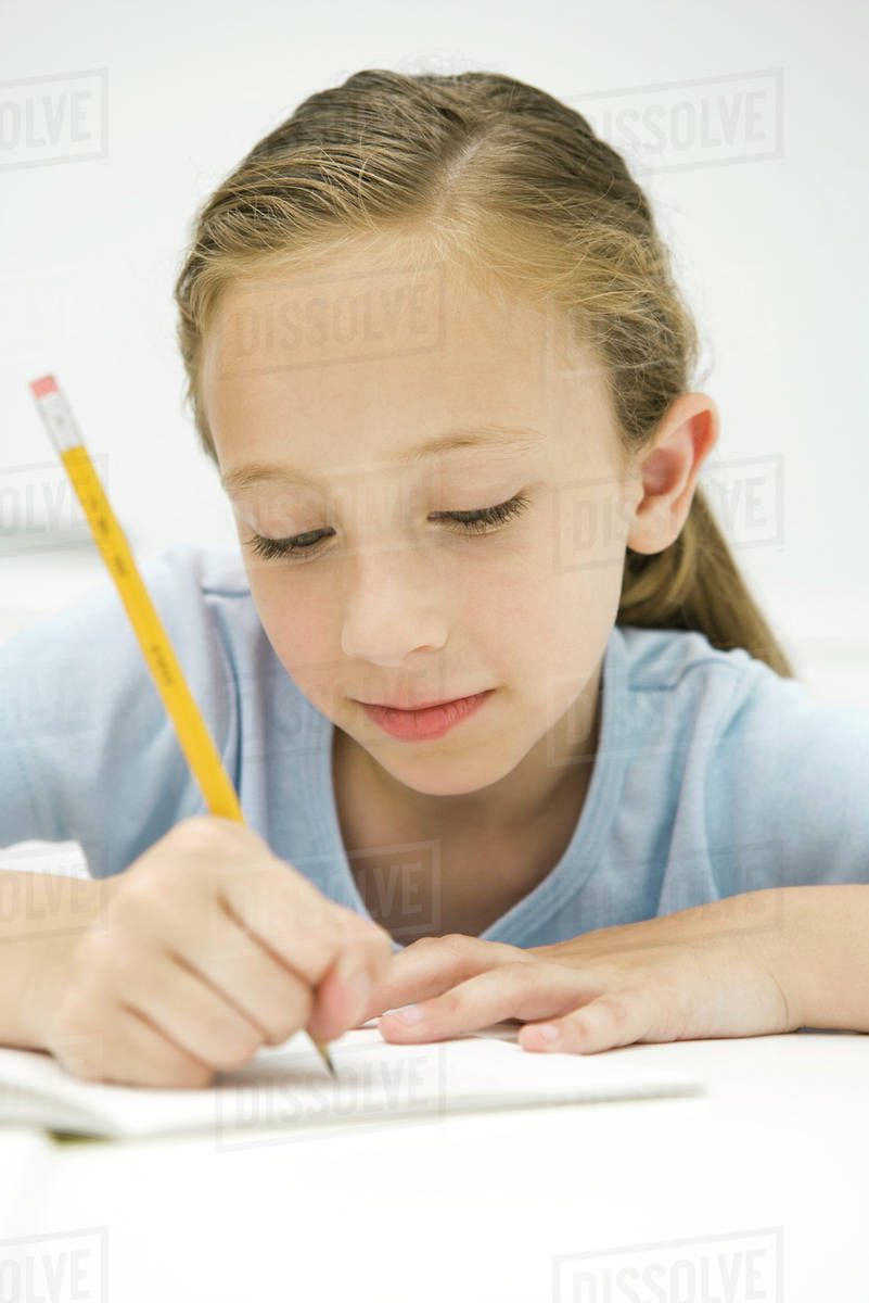 Girl writing with pencil, close-up - Royalty-free Stock Photo | Dissolve