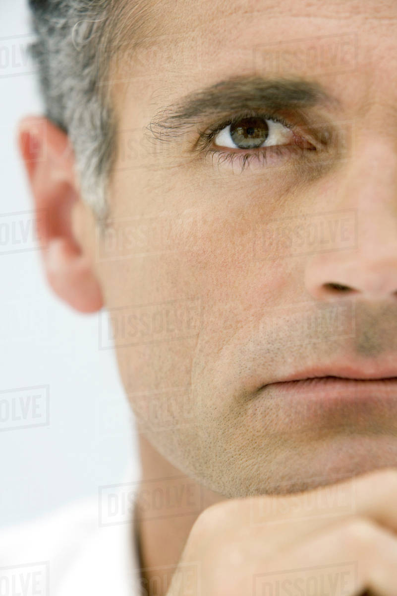 Man holding chin, looking at camera, cropped portrait - Royalty-free ...