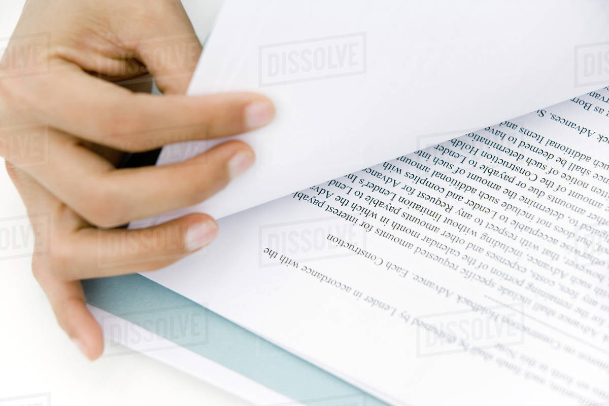 Hand turning document page, close-up - Stock Photo - Dissolve