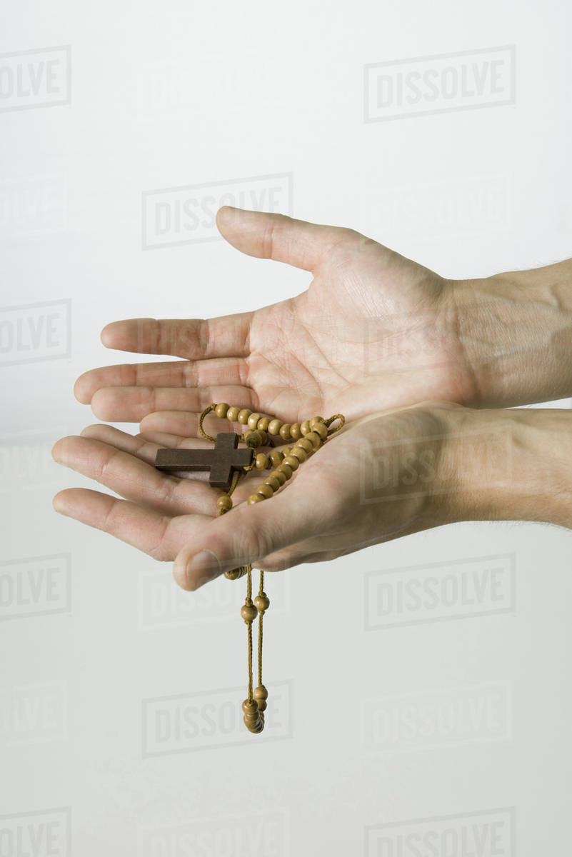 Hands holding rosary - Royalty-free Stock Photo | Dissolve