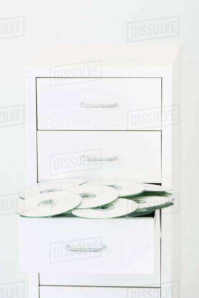 Open drawer overflowing with CDs - Royalty-free Stock Photo | Dissolve