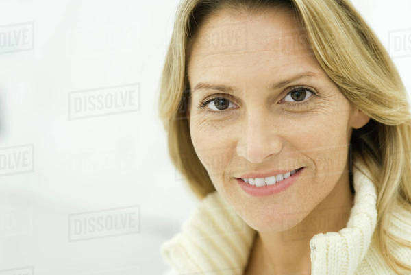 Woman smiling at camera, portrait - Stock Photo - Dissolve