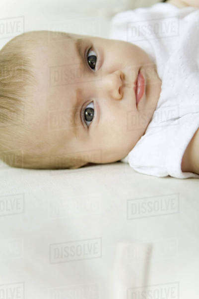 Baby lying on back, looking at camera, close-up - Royalty-free Stock ...