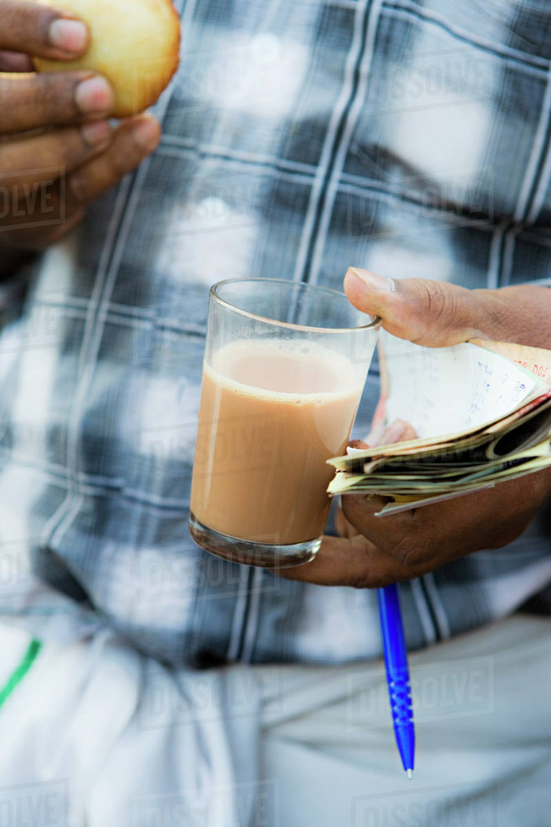 Man holding glass of chai tea, mid section - Royalty-free Stock Photo ...
