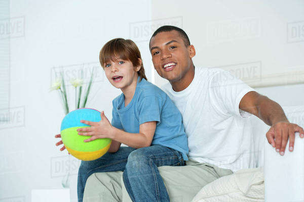 Son sitting on father's lap - Royalty-free Stock Photo | Dissolve