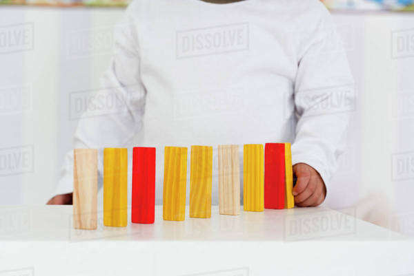 Baby lining up blocks, mid section - Royalty-free Stock Photo | Dissolve