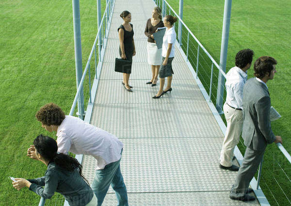 People standing in small groups on walkway, high angle view - Royalty ...