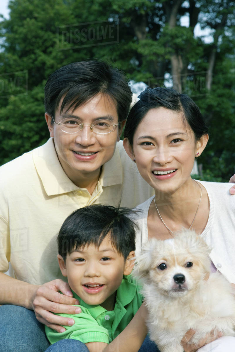 Boy with parents and pet dog, portrait - Stock Photo - Dissolve