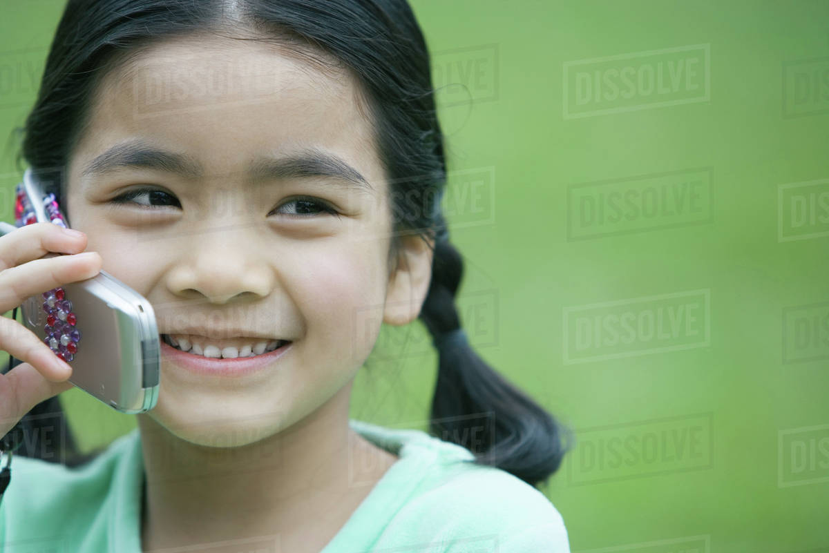 Little girl using cell phone, close-up - Stock Photo - Dissolve