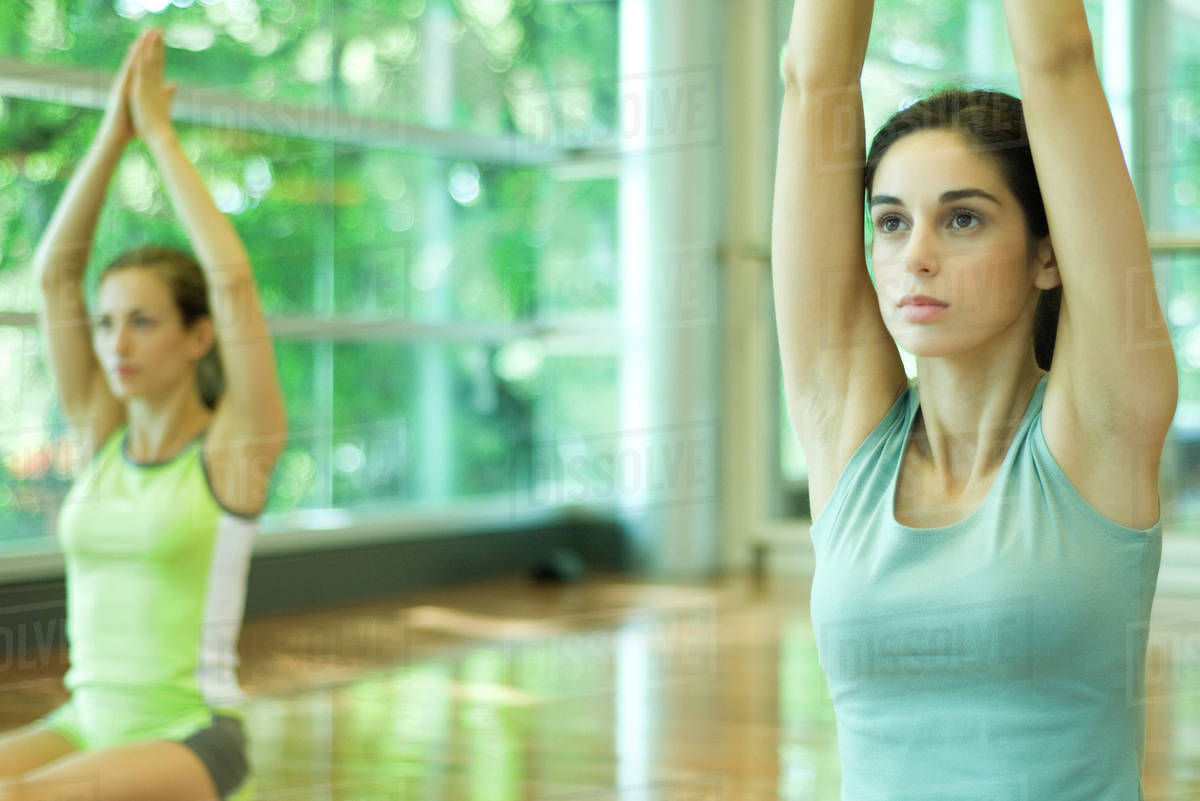 Women kneeling with arms raised overhead - Royalty-free Stock Photo ...