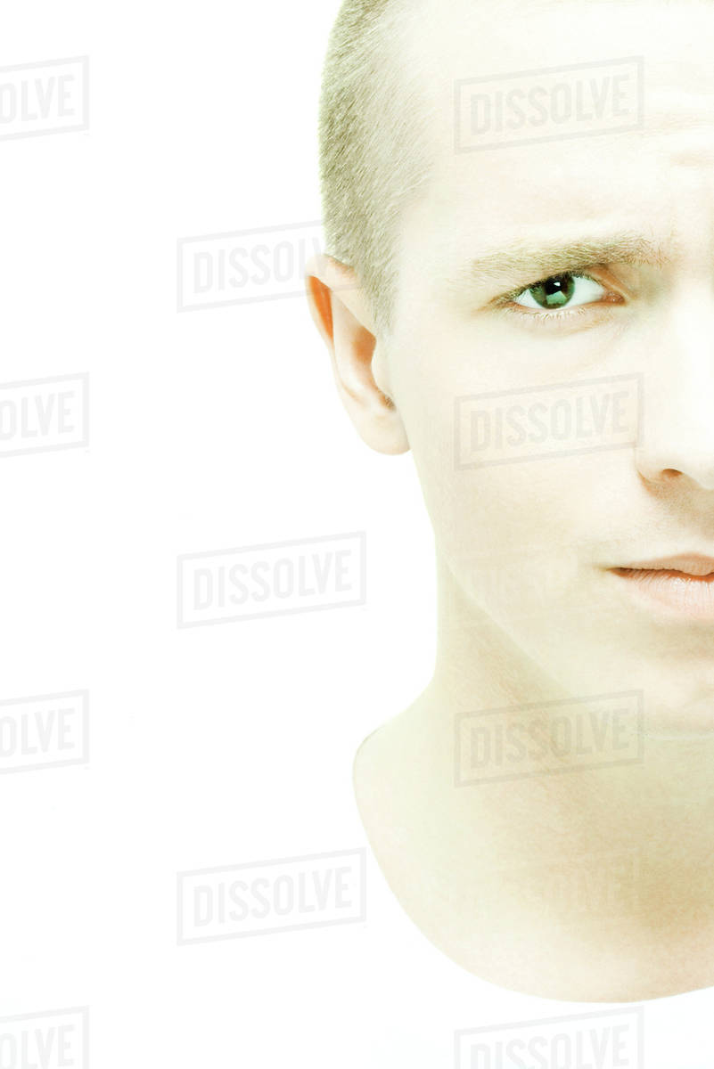 Young man furrowing brow at camera - Stock Photo - Dissolve
