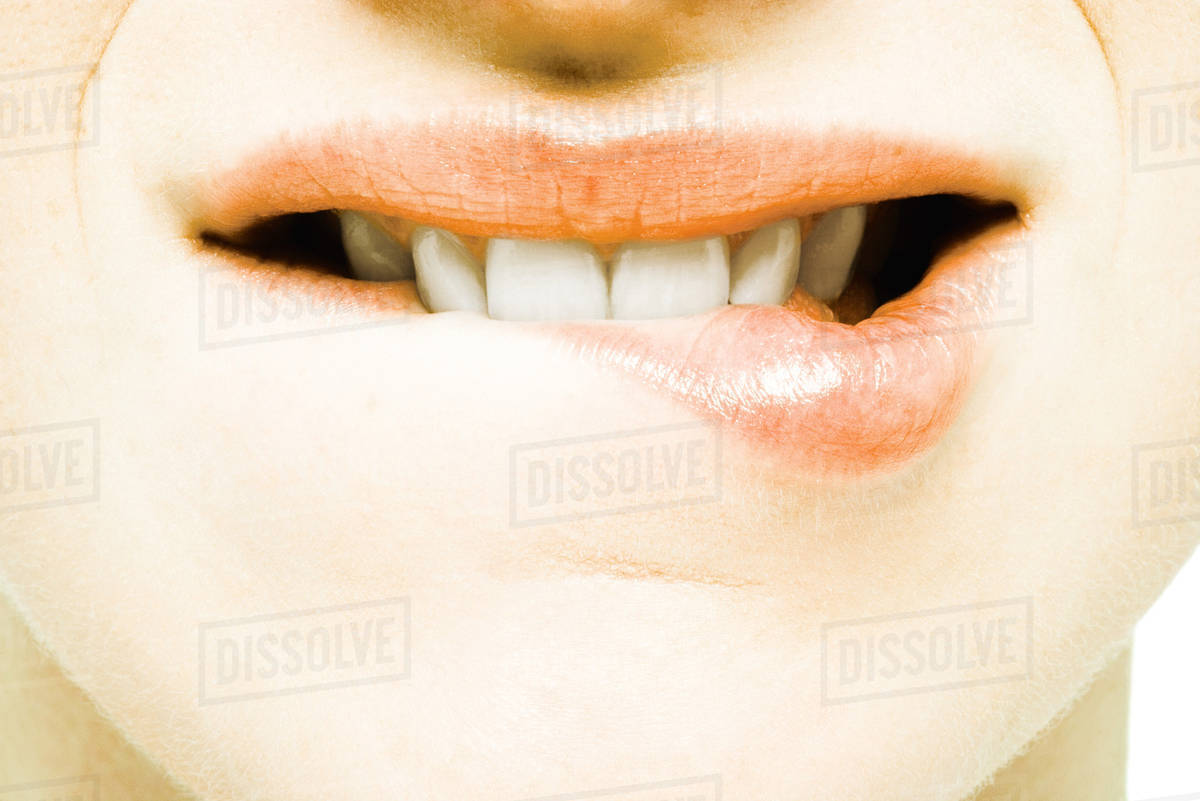 Teenage girl biting lip, extreme close-up - Stock Photo - Dissolve
