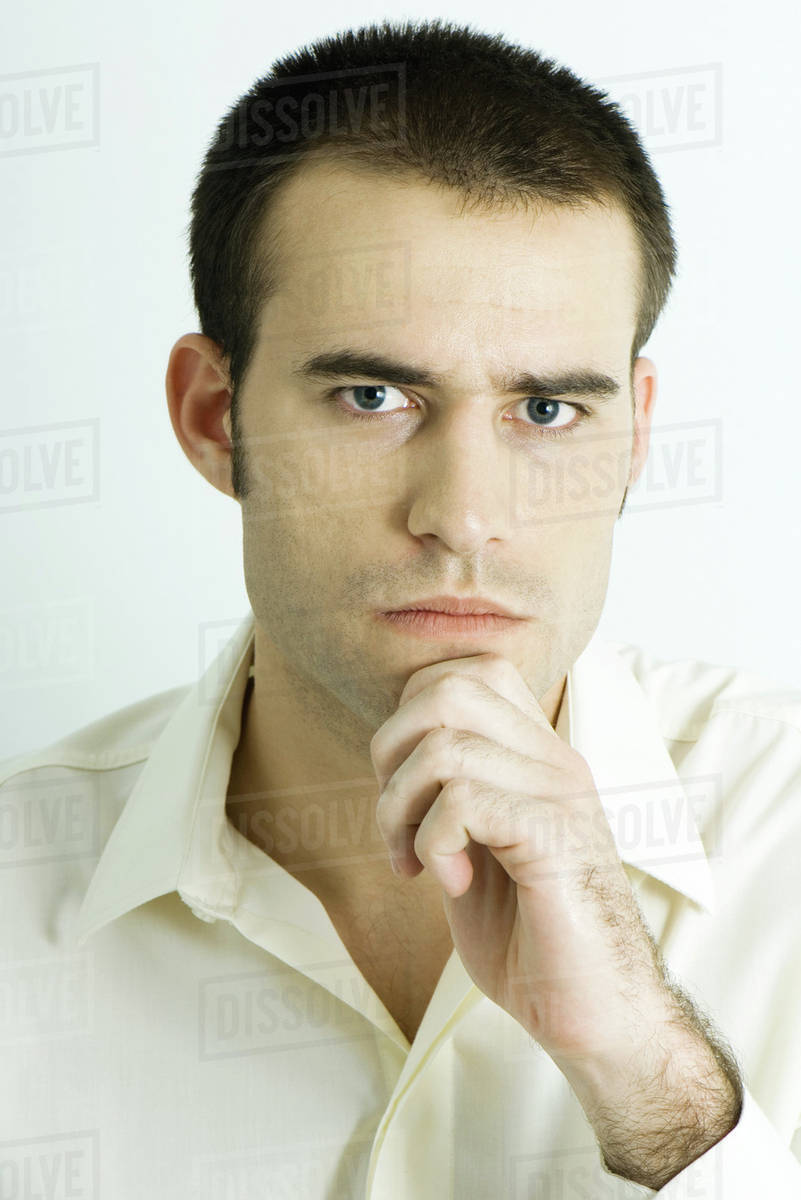 Man with hand under chin, portrait - Royalty-free Stock Photo | Dissolve