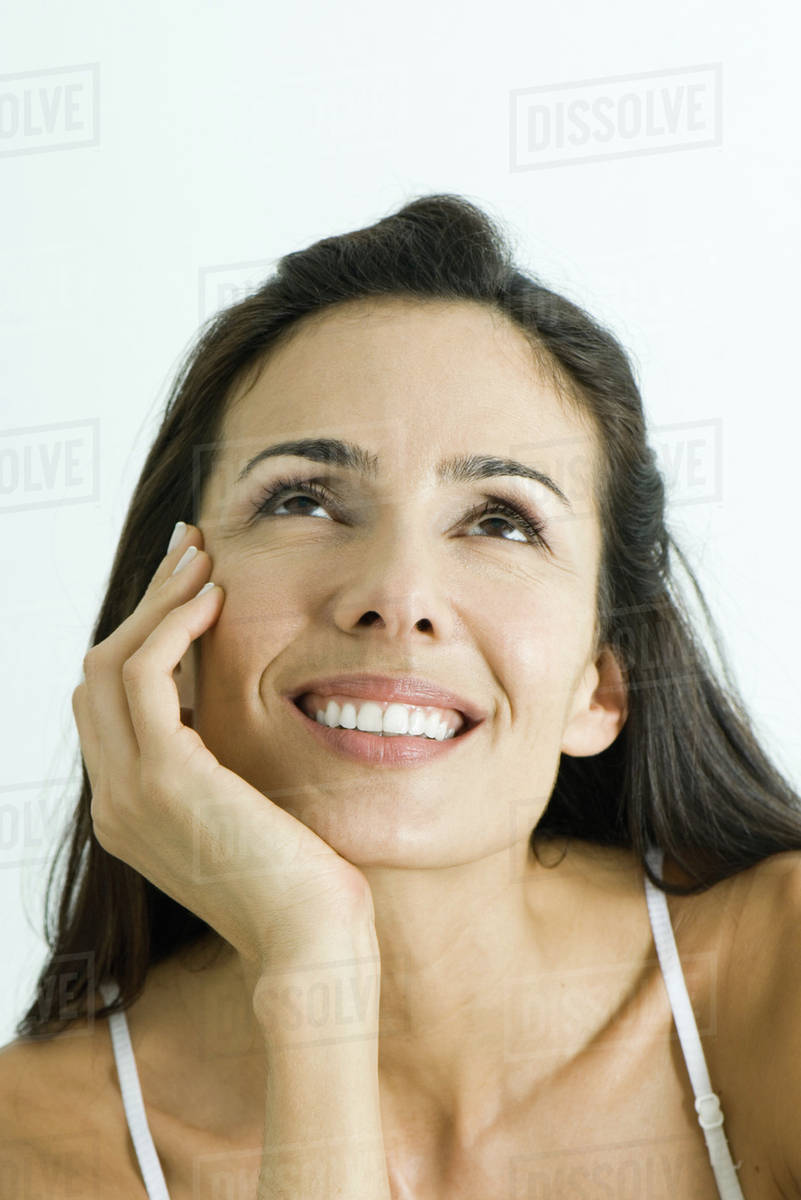 Woman resting head on hand, smiling, looking up, portrait - Royalty ...