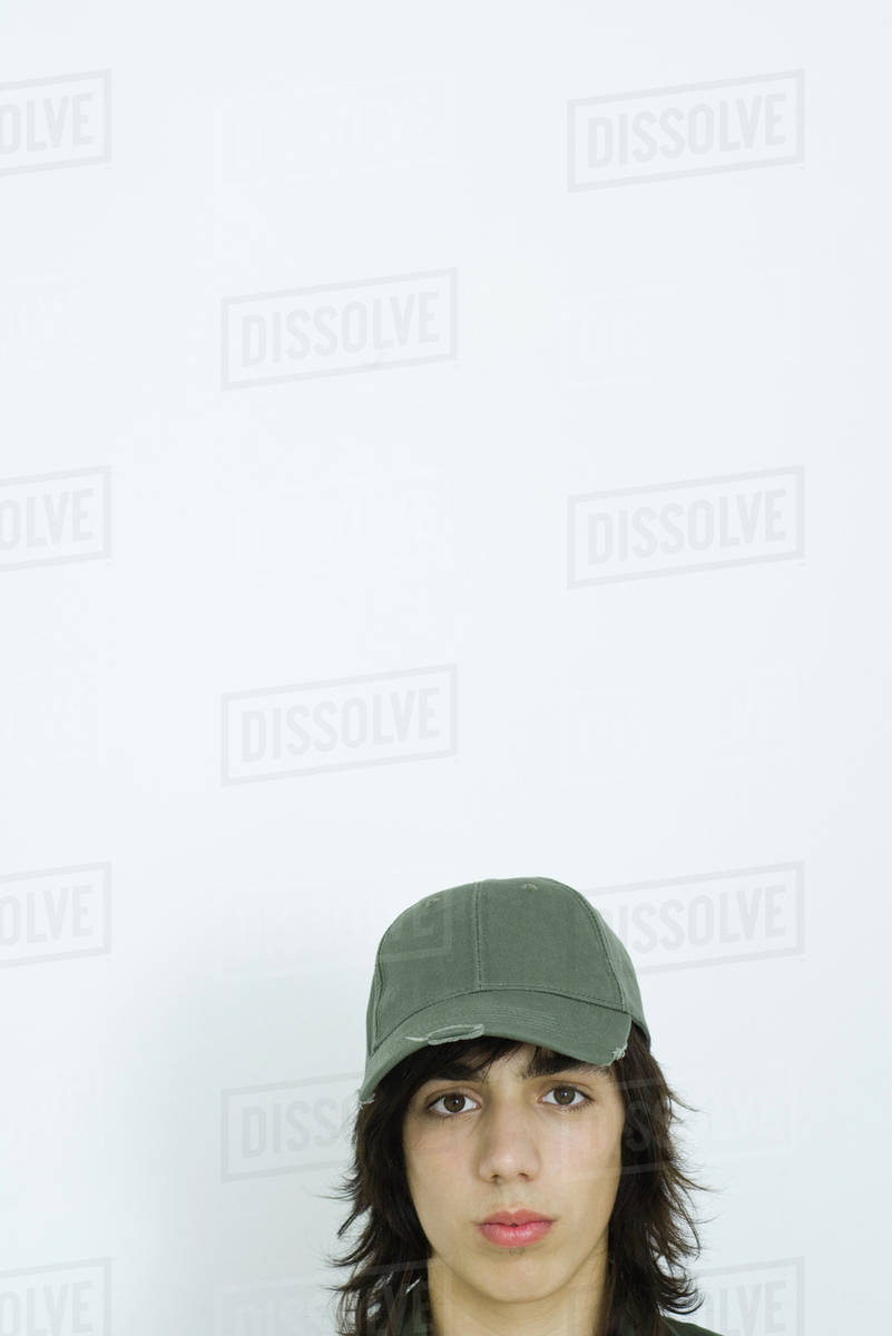 Teen boy wearing cap, portrait - Royalty-free Stock Photo | Dissolve