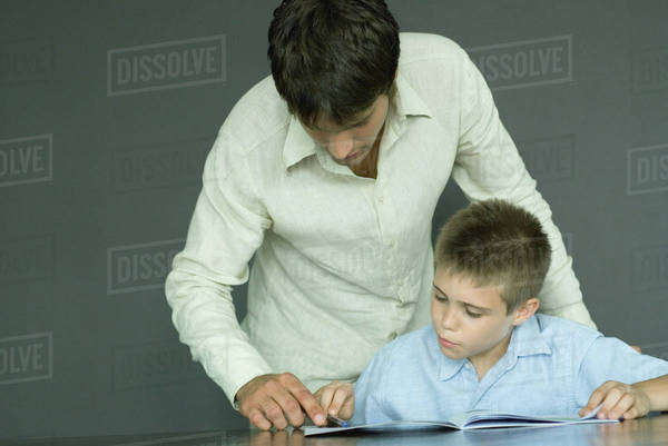 Man helping boy with homework - Royalty-free Stock Photo | Dissolve