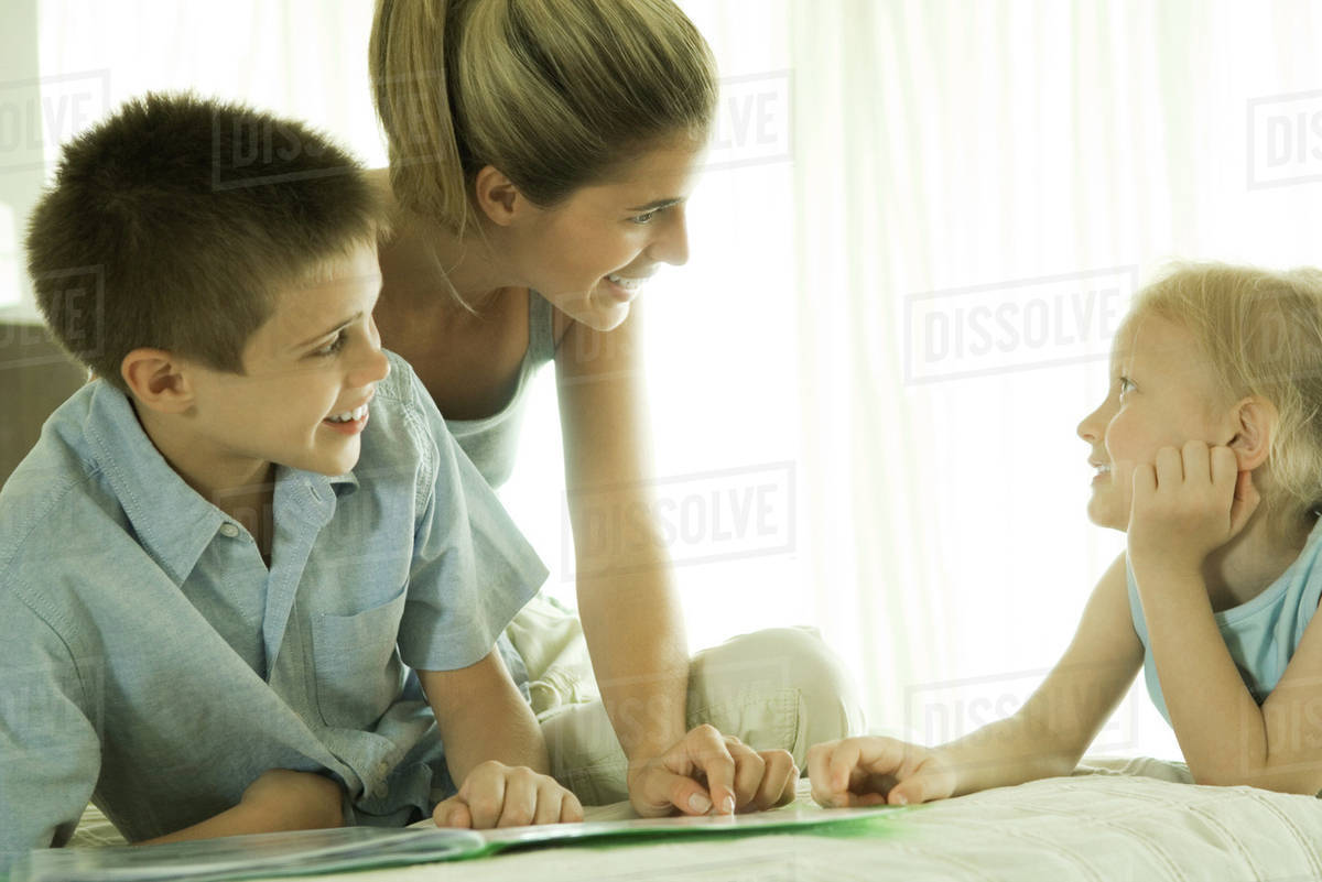 Mother helping children with homework - Royalty-free Stock Photo | Dissolve