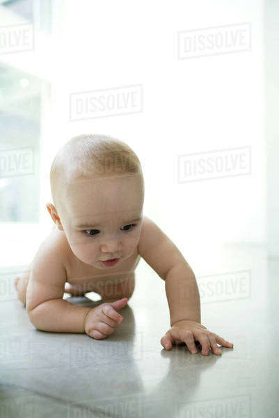 Baby crawling on floor - Royalty-free Stock Photo | Dissolve