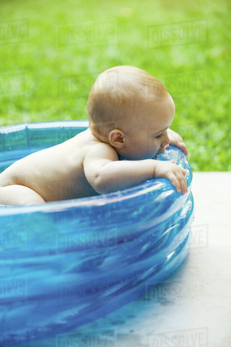 Baby in inflatable baby pool - Stock Photo - Dissolve