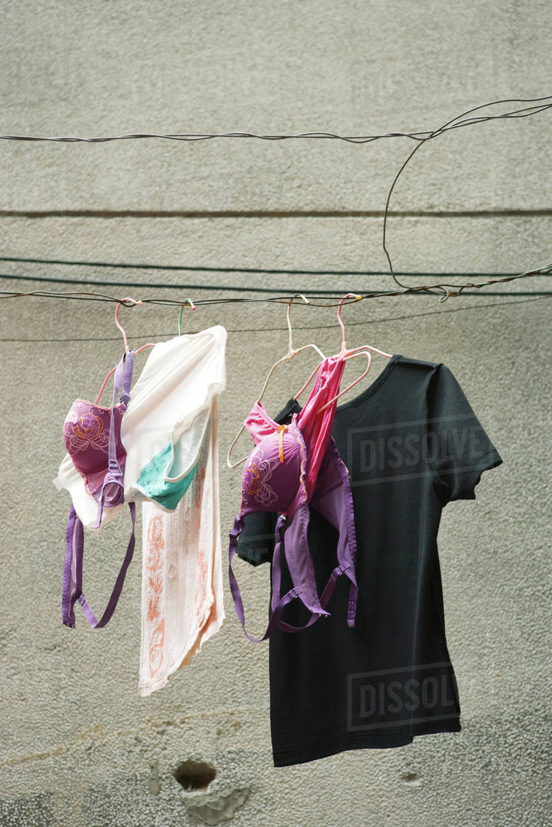 Laundry hanging on cable - Stock Photo - Dissolve