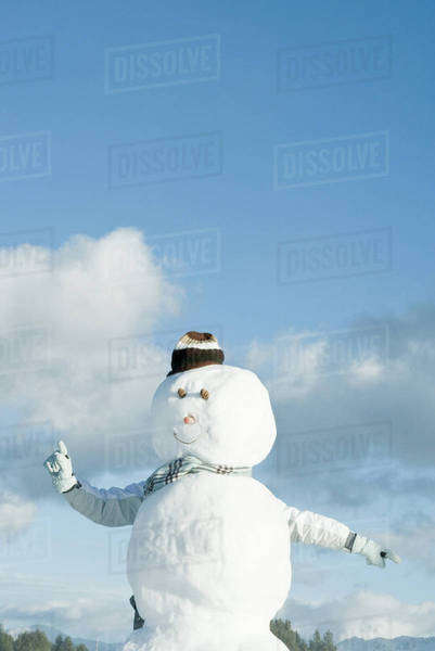 Person sticking arms out from behind snowman - Royalty-free Stock Photo ...