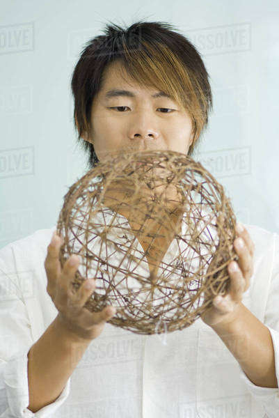 Man holding up sphere - Royalty-free Stock Photo | Dissolve