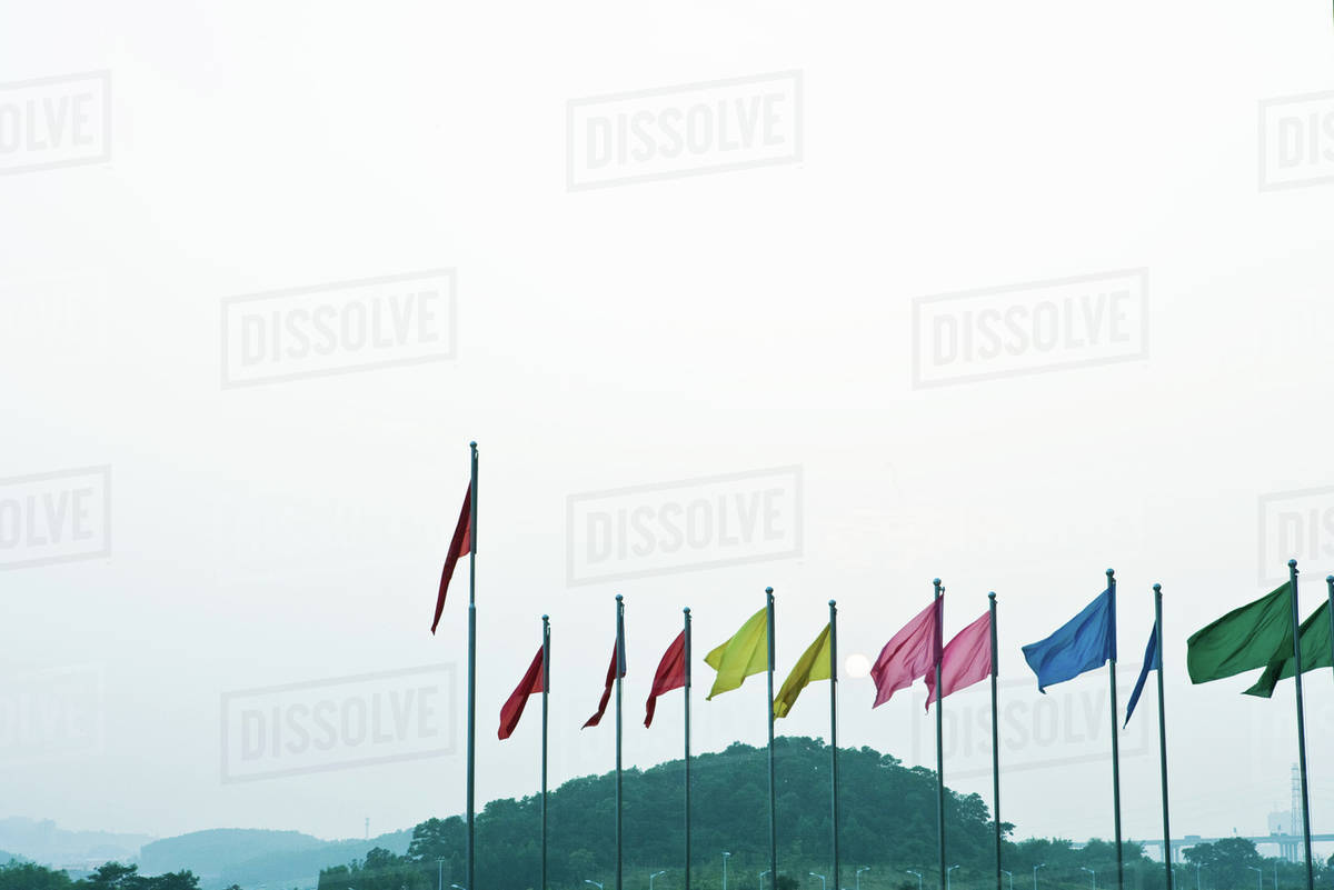 Flags, landscape in background - Stock Photo - Dissolve
