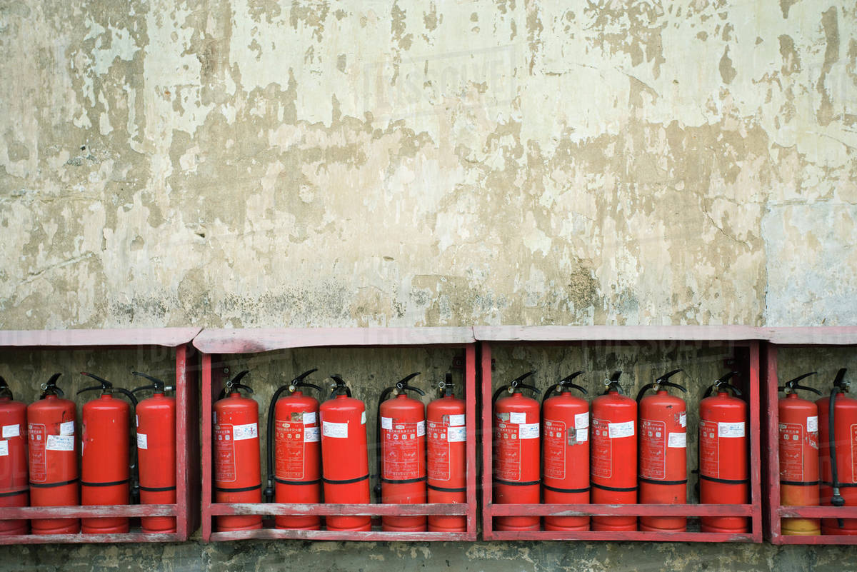 Row of fire extinguishers - Royalty-free Stock Photo | Dissolve