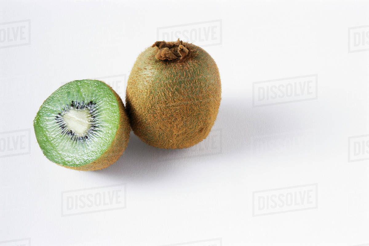 Two kiwis, one cut, the other whole, close-up - Royalty-free Stock ...