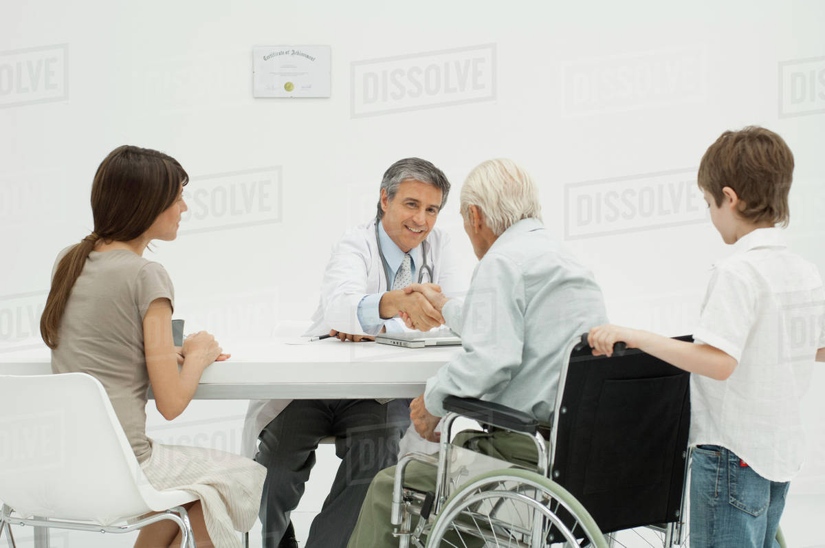 Doctor talking with senior patient and his family - Royalty-free Stock ...