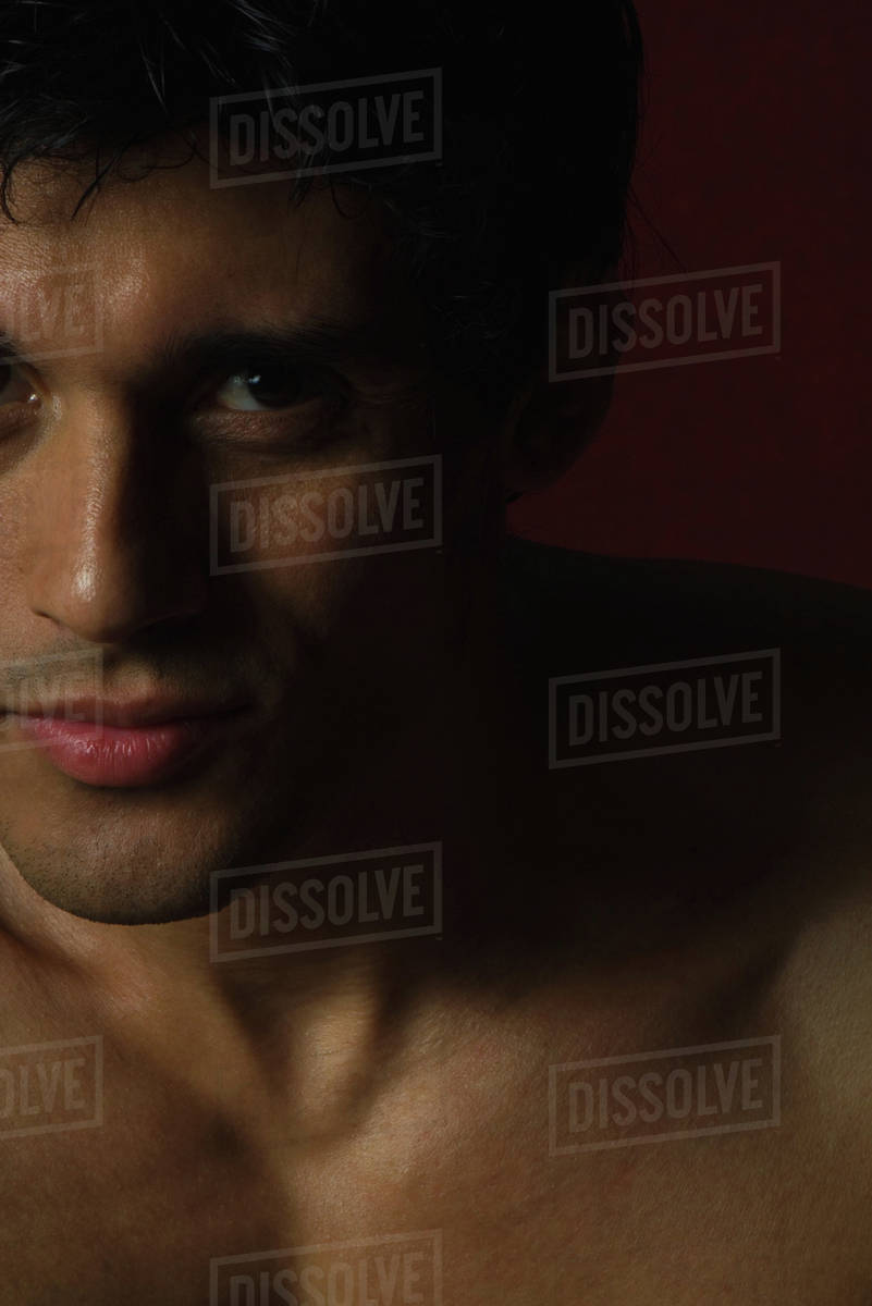 Barechested man looking at camera, close-up of face and chest - Royalty ...