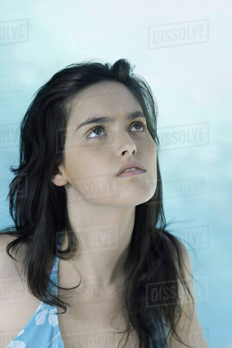 Woman looking up, portrait - Royalty-free Stock Photo | Dissolve