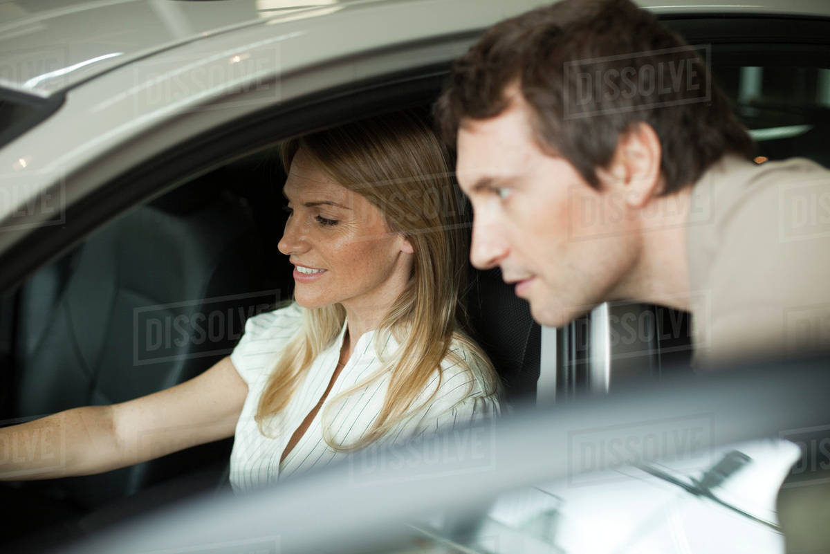 Couple checking out new car - Royalty-free Stock Photo | Dissolve