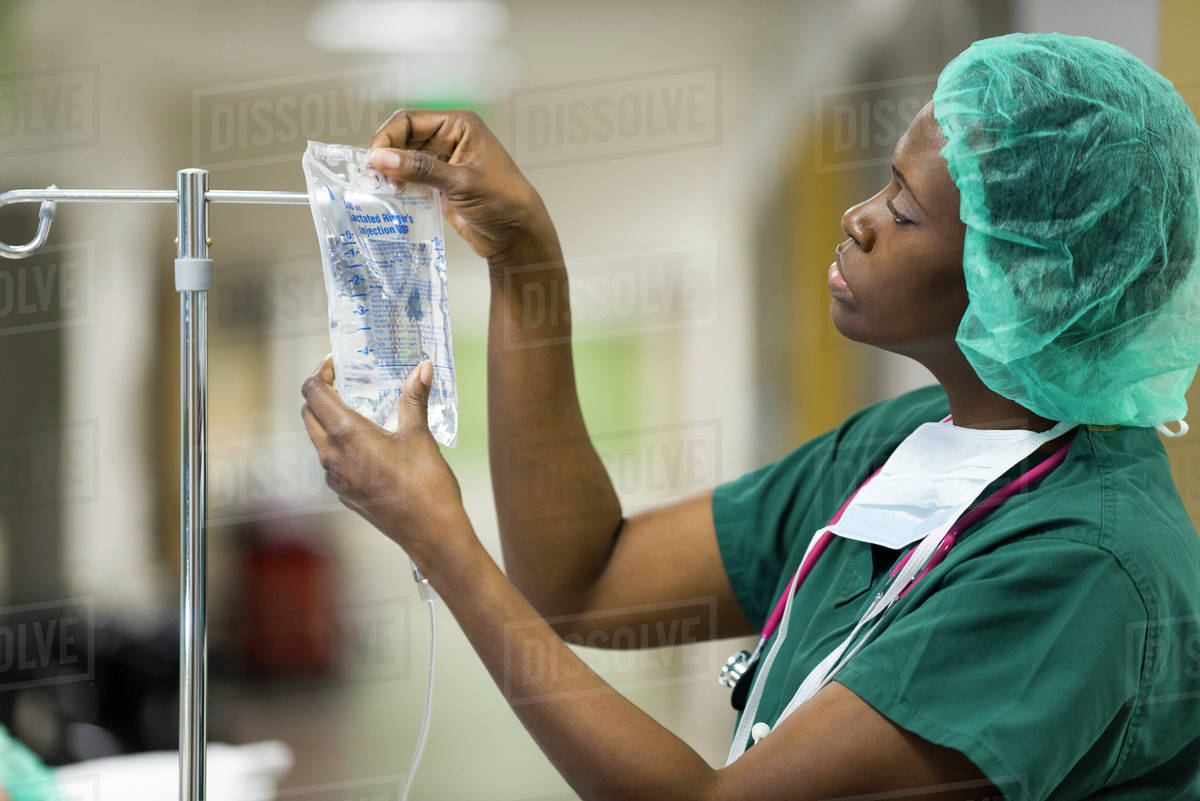 Nurse preparing IV drip - Royalty-free Stock Photo | Dissolve